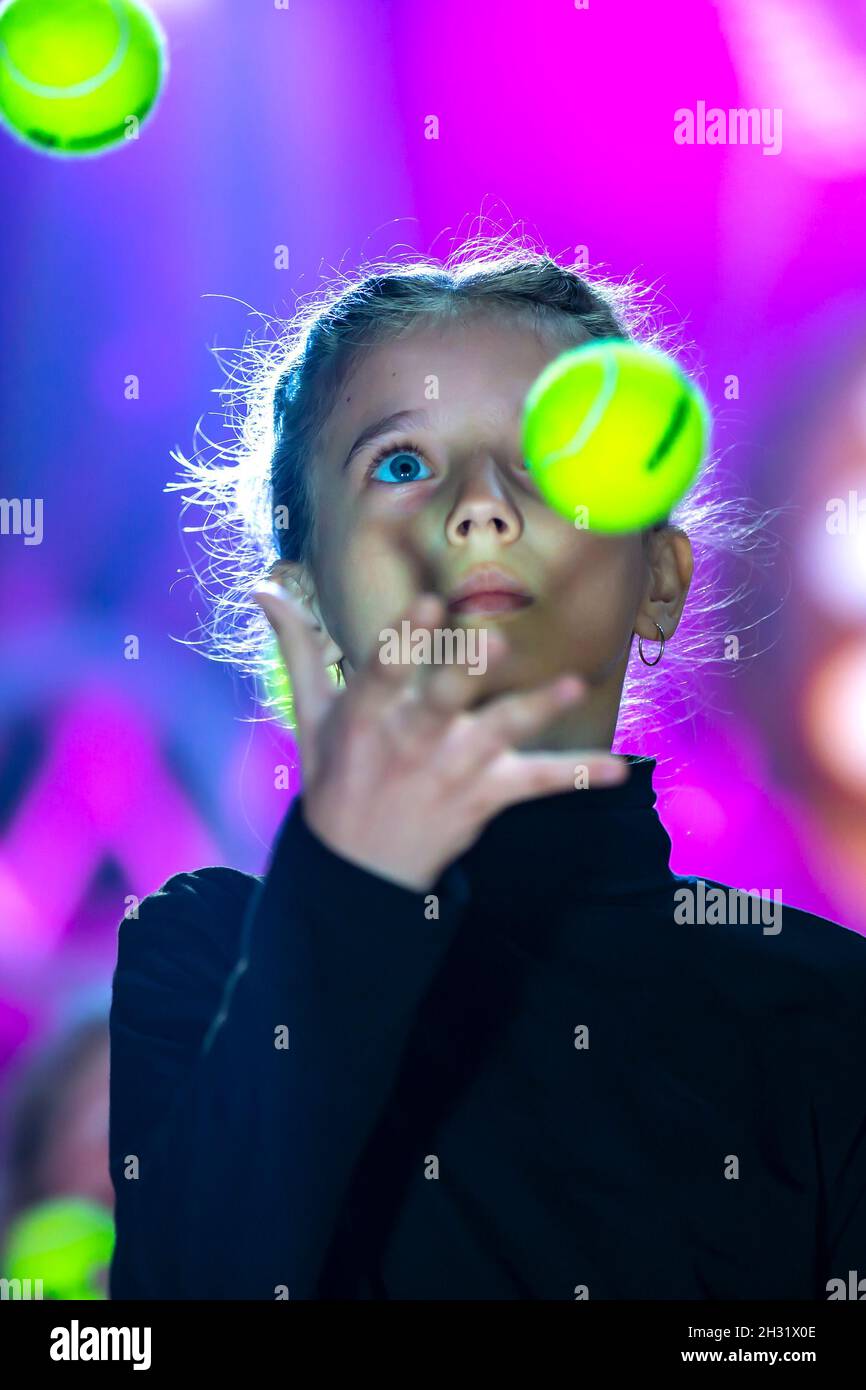 Little girl juggles balls. The circus art of juggling Stock Photo - Alamy