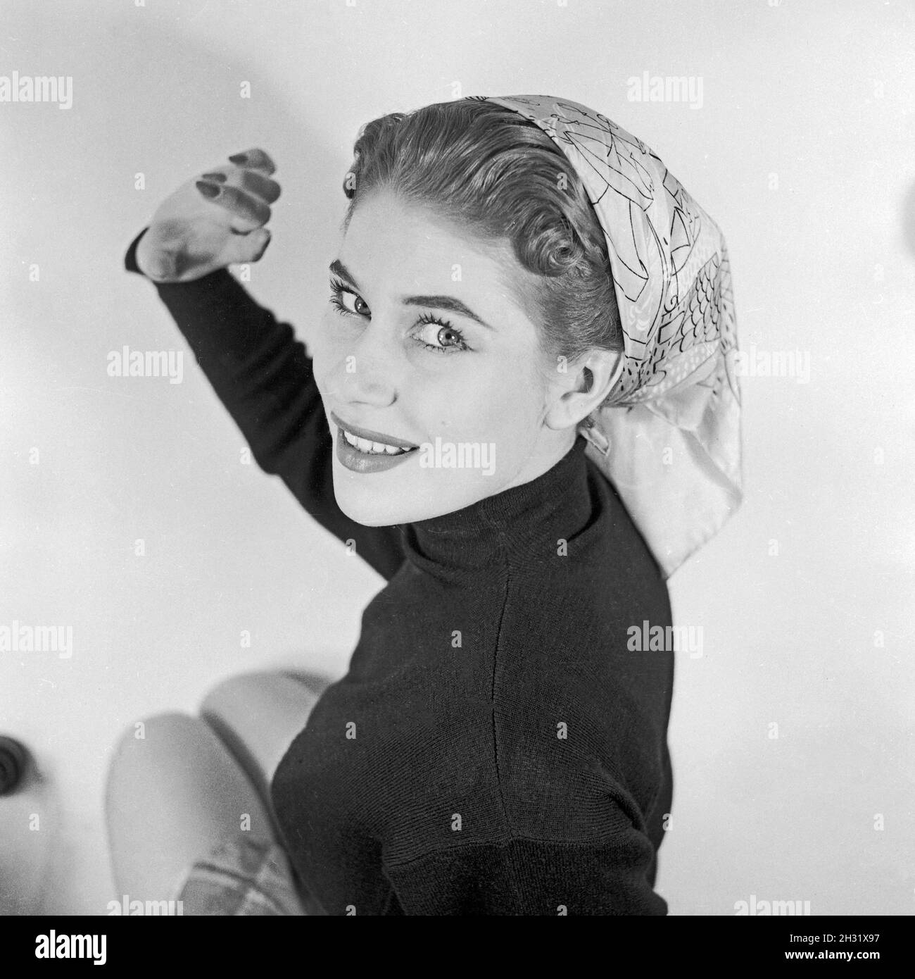 Eine junge Frau mmit einem Kopftuch posiert für den Fotografen ...