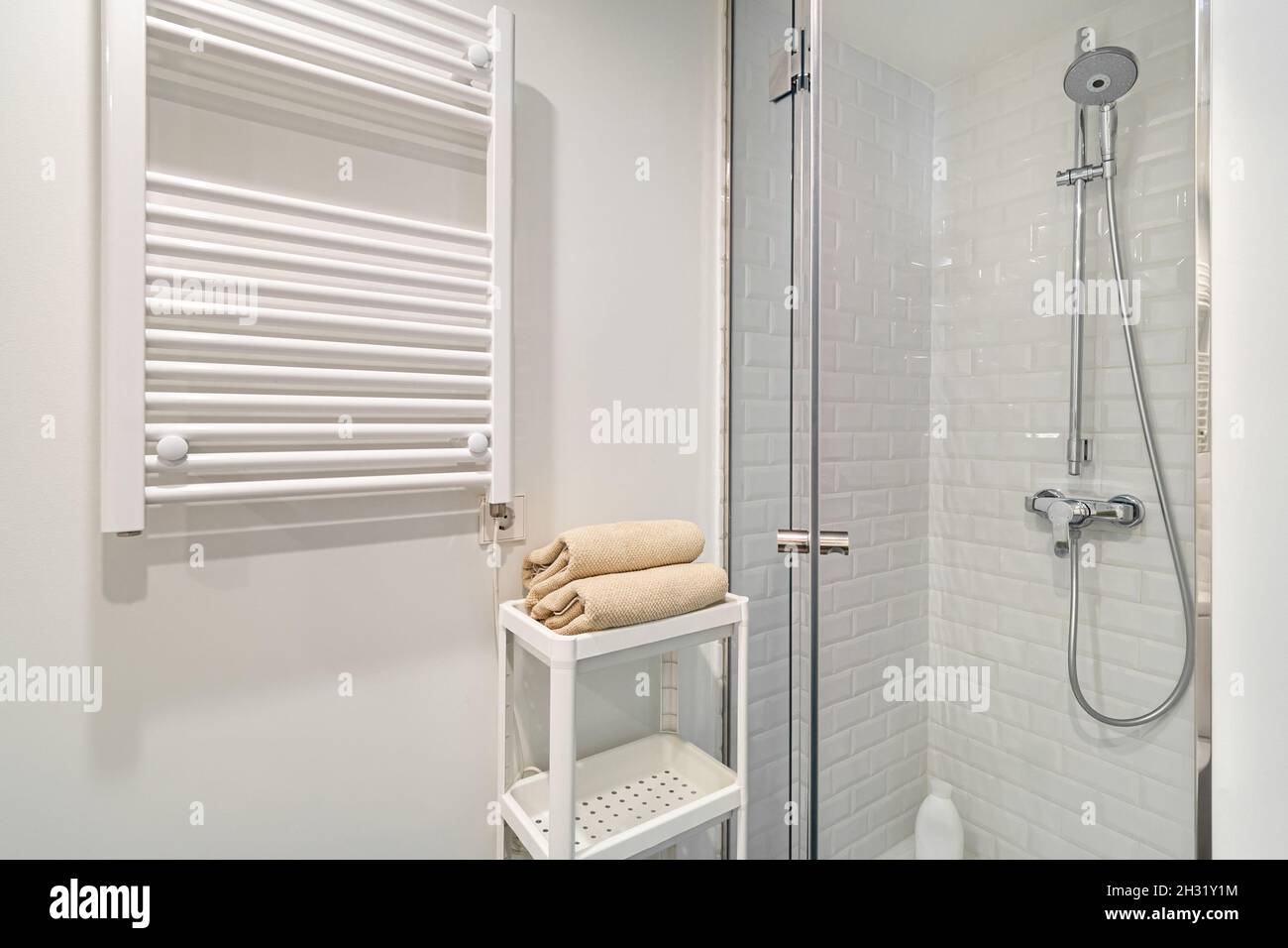 Interior of white bathroom with shower zone and towels heater Stock ...