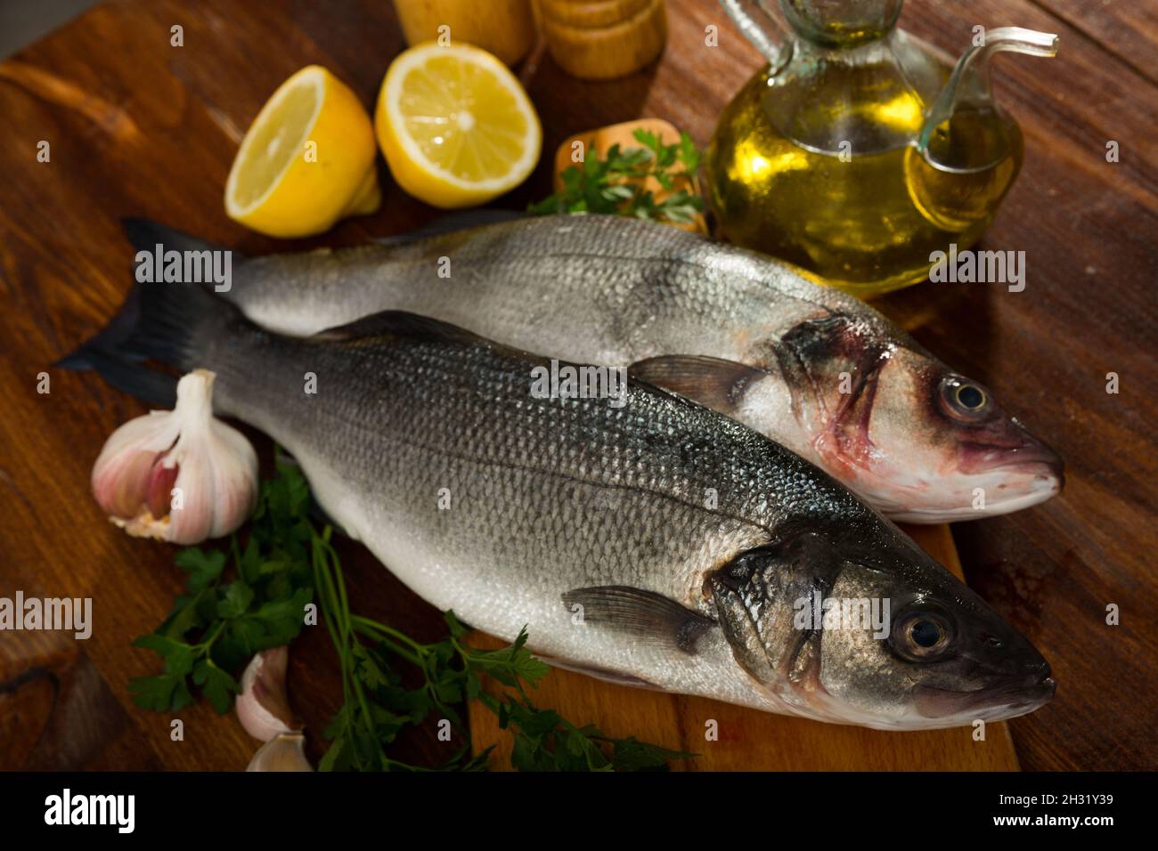 Two raw sea bass fish Stock Photo - Alamy