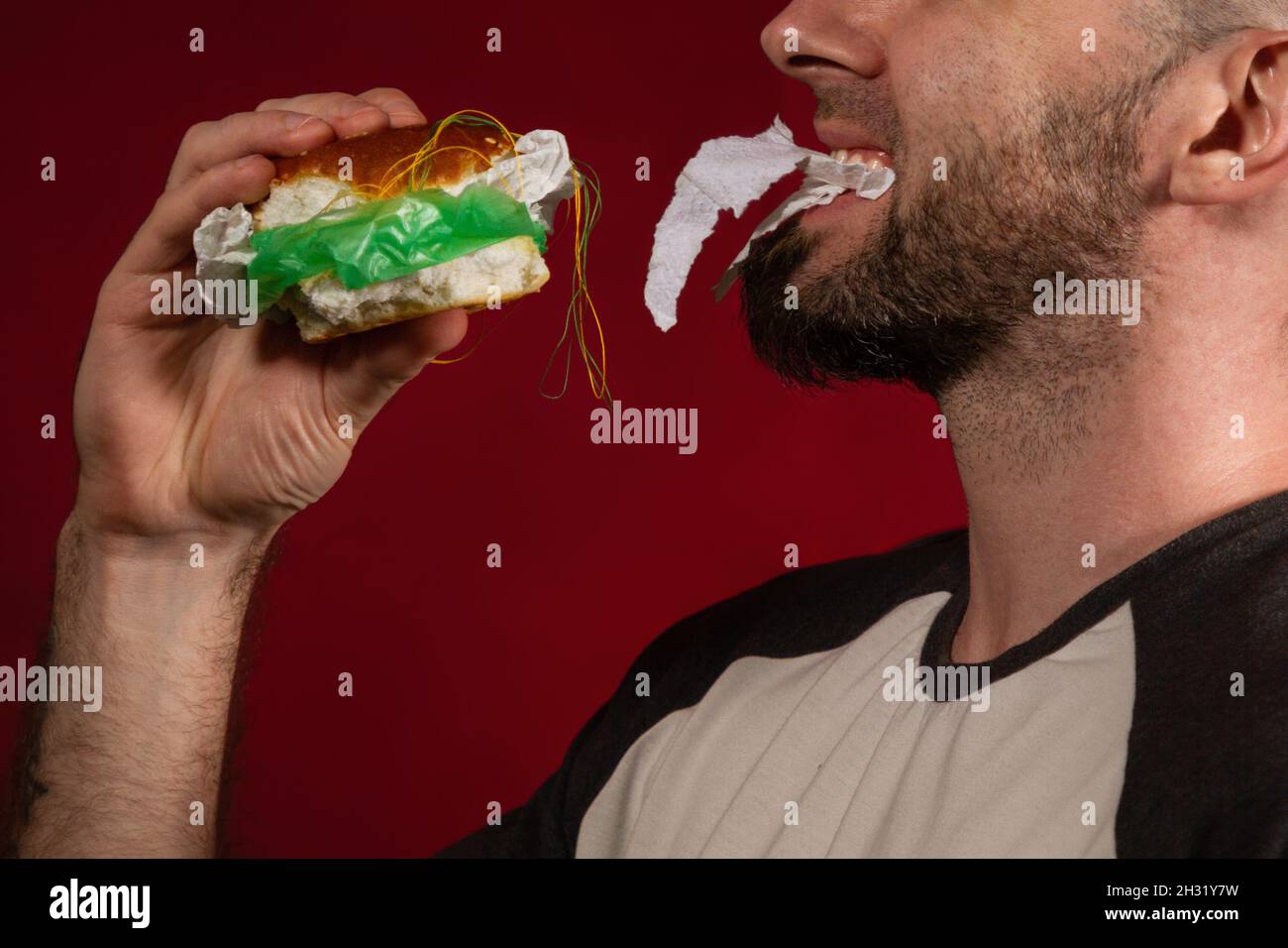 The concept of fast food and ecology. A bald man with a beard, happily ...