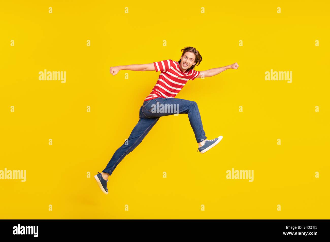 Photo of funky pretty young guy dressed red t-shirt jumping high ...