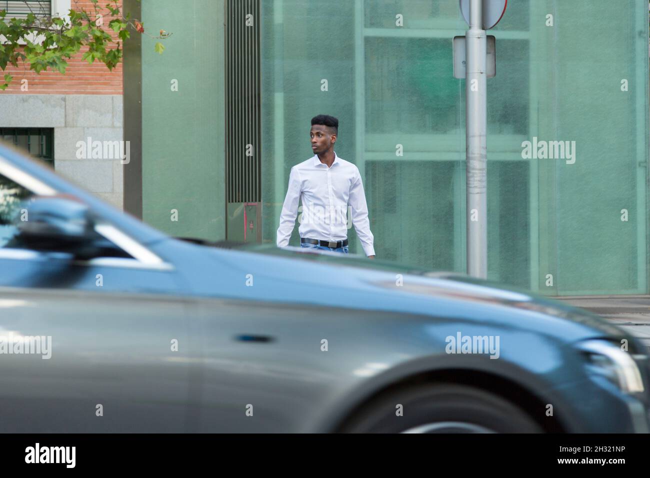 young black man crossing the street in traffic Stock Photo - Alamy