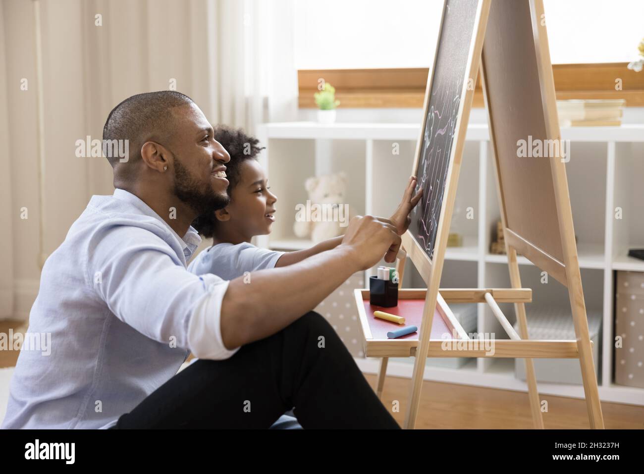 Happy african american family drawing on board Stock Photo - Alamy