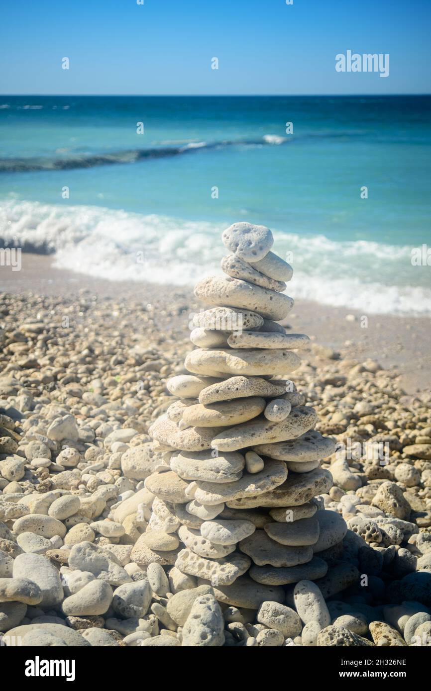 Pile of stone on the beach on the lighthouse Phare des Baleines on the ...