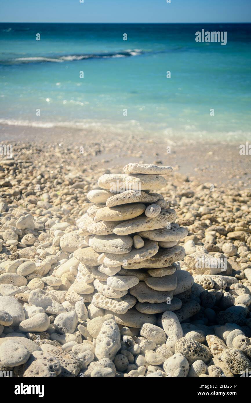 Pile of stone on the beach on the lighthouse Phare des Baleines on the ...