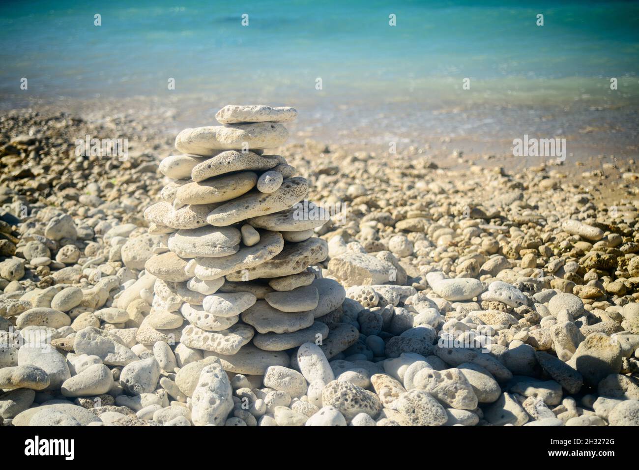 Pile of stone on the beach on the lighthouse Phare des Baleines on the ...