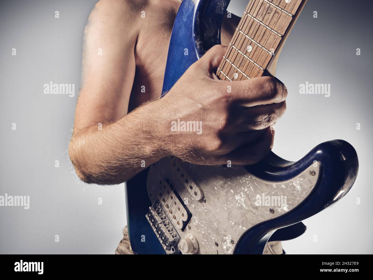 Guitar player holding guitar in hand Stock Photo - Alamy