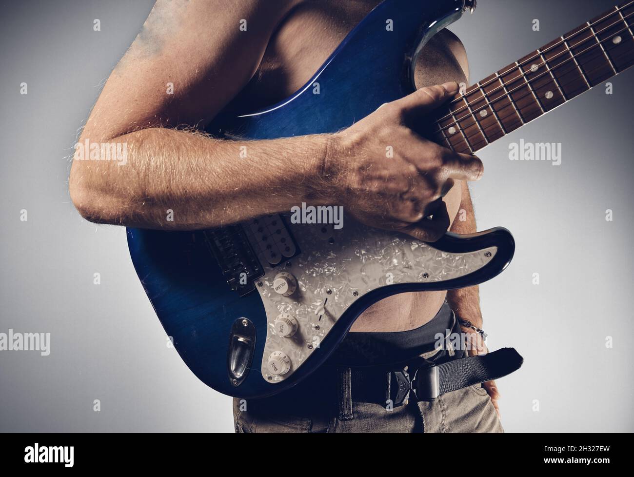 Guitar player holding guitar in hand Stock Photo - Alamy