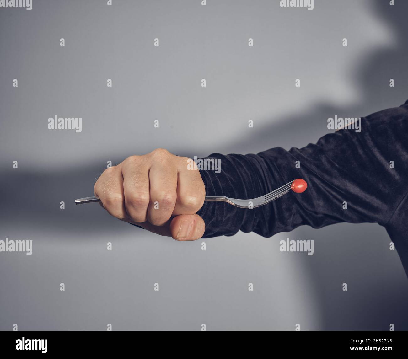 rosehip spiked on fork with male hand Stock Photo - Alamy