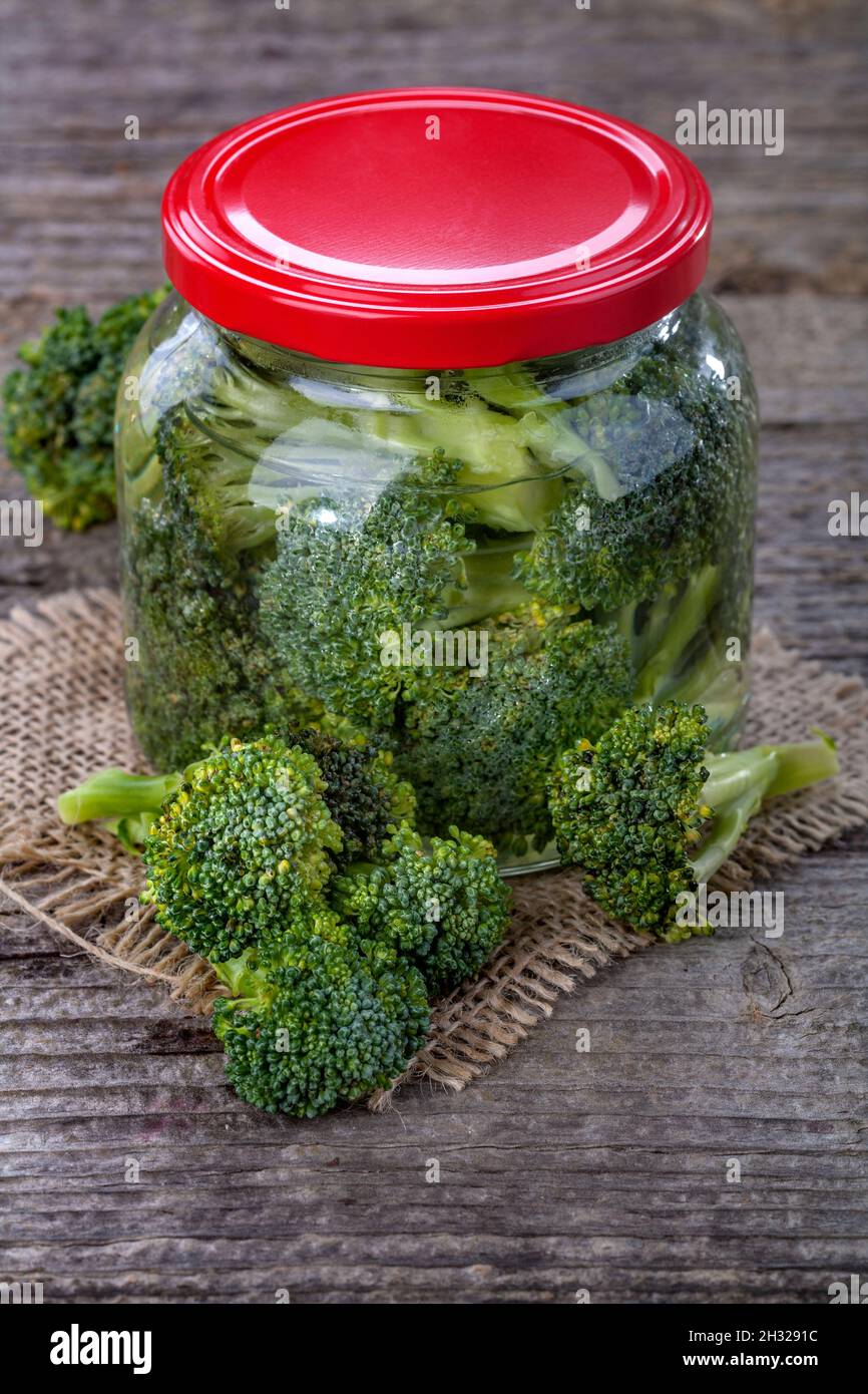Domestic healthy canned broccoli on a wooden table Stock Photo - Alamy