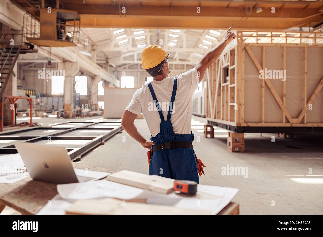 Male builder pointing finger at something at construction site Stock ...