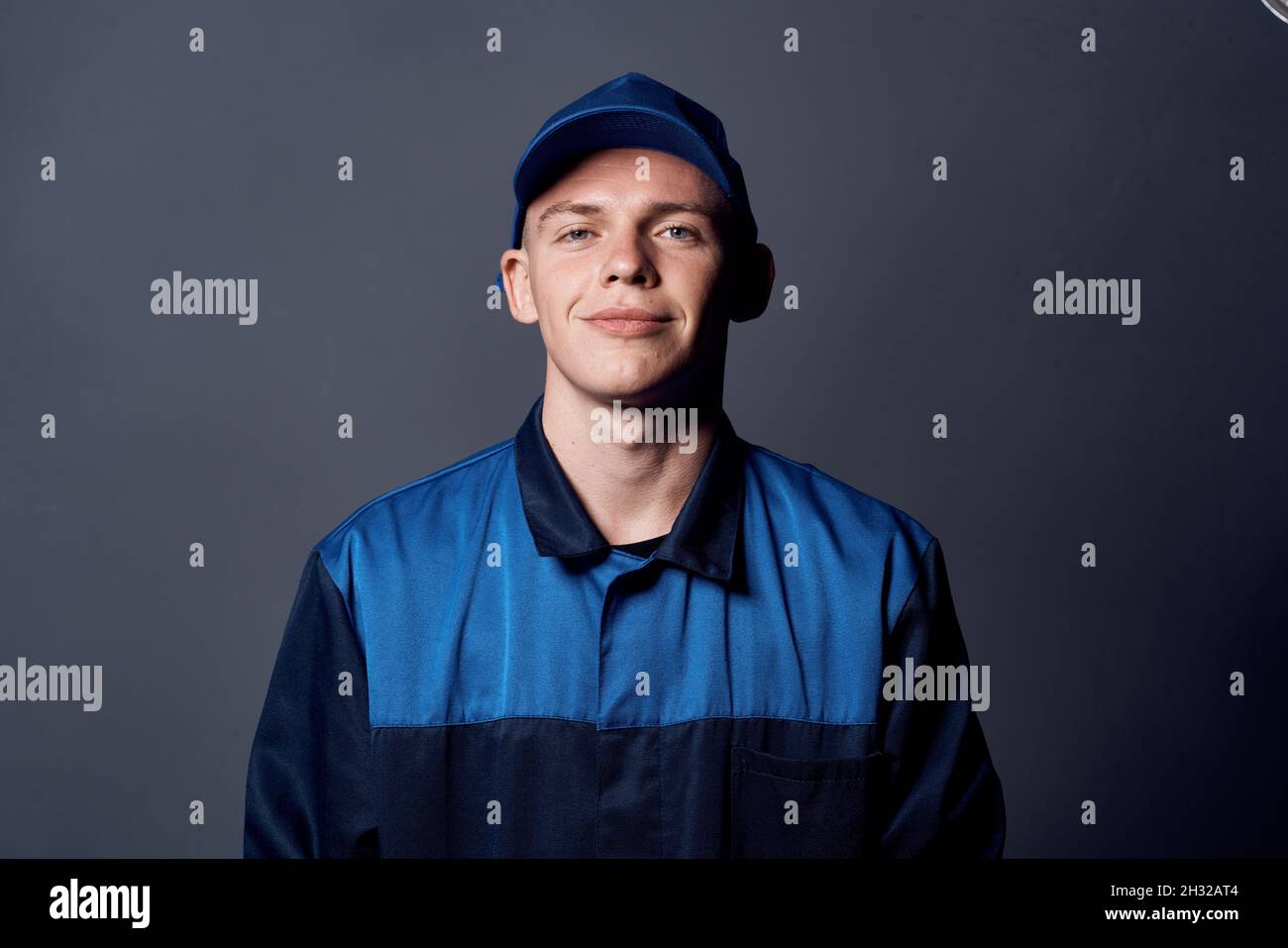 man in work uniform blue cap close-up of service Stock Photo - Alamy
