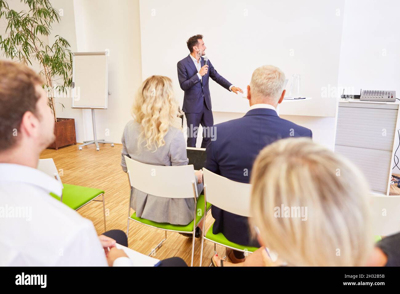 Business man as a speaker at a lecture with presentation in a seminar ...