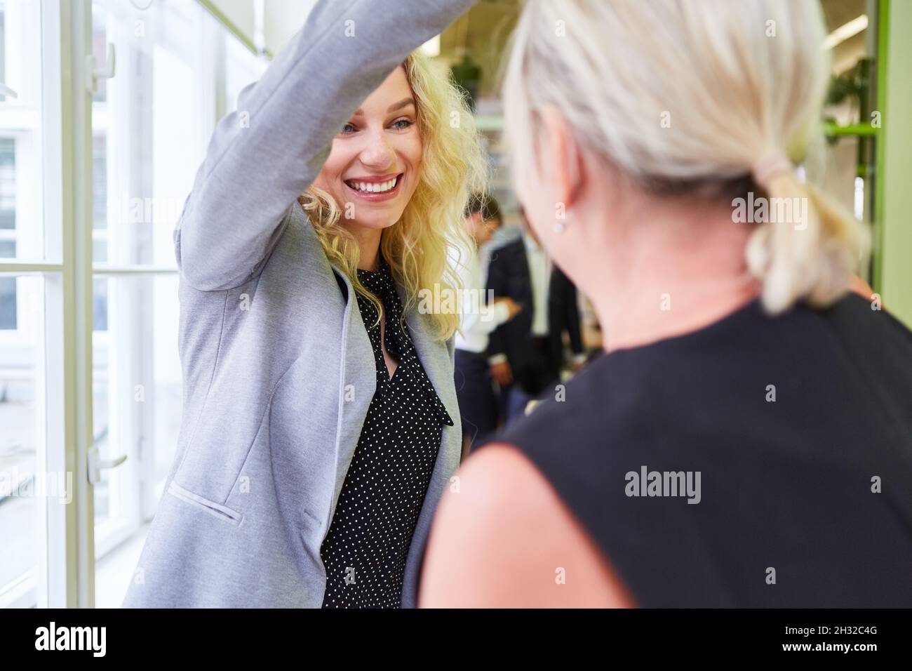 Two business women celebrate collaboration and success with a high five ...