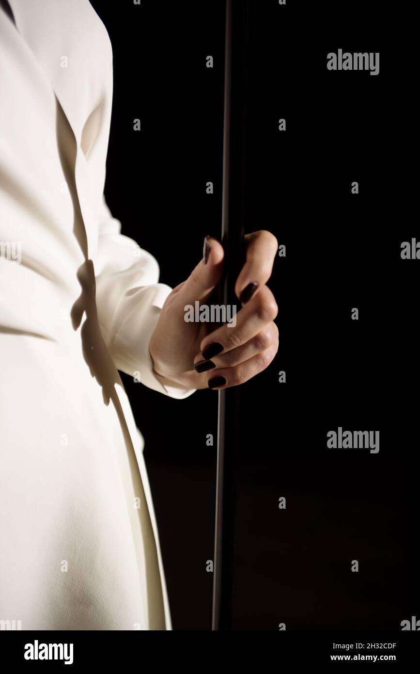 Back view of a singer with microphone singing a song on stage in white ...