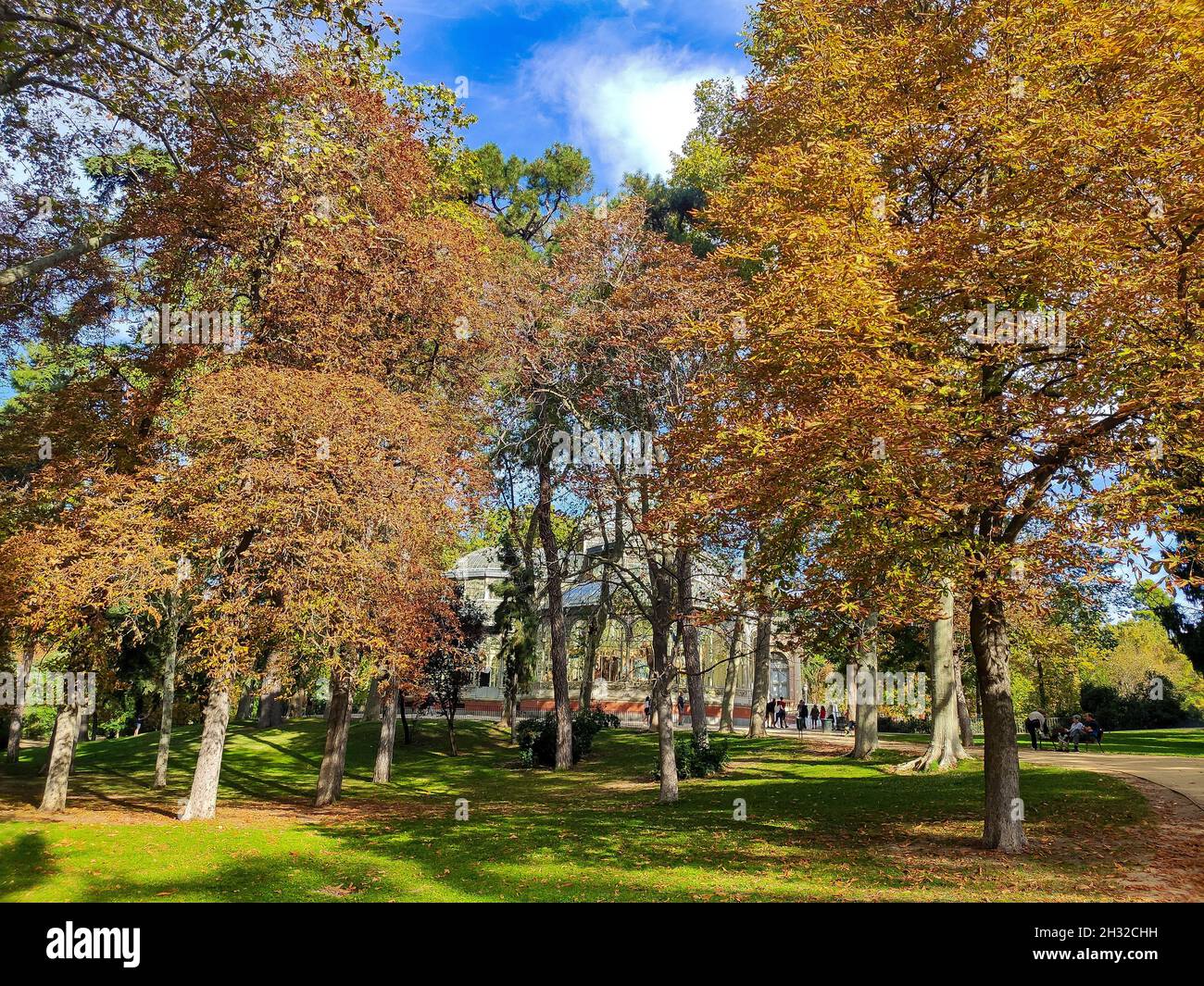 The Crystal Palace in Madrid's Retiro Park with an autumnal landscape ...