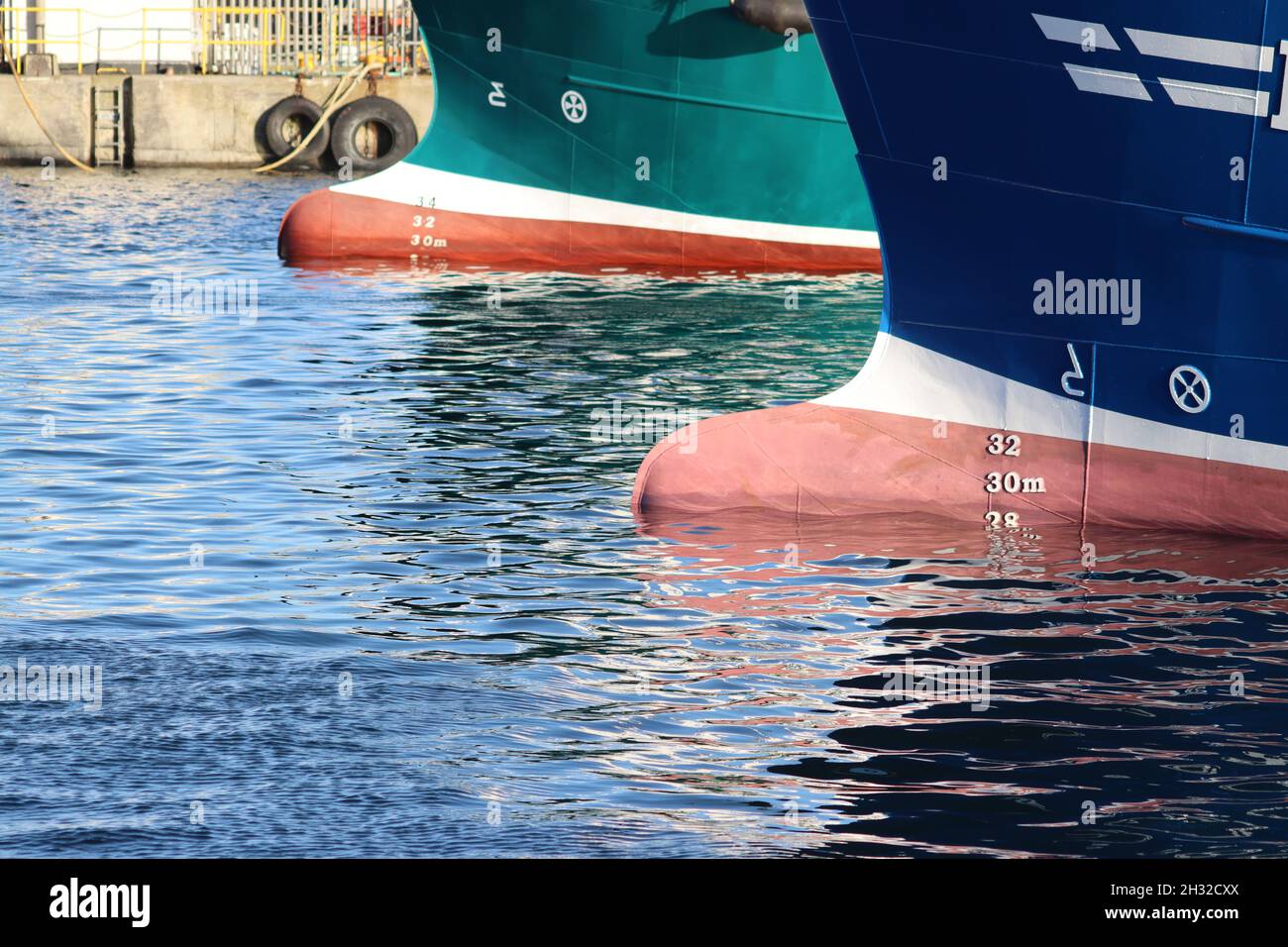 Fishing boat hulls in water Stock Photo - Alamy
