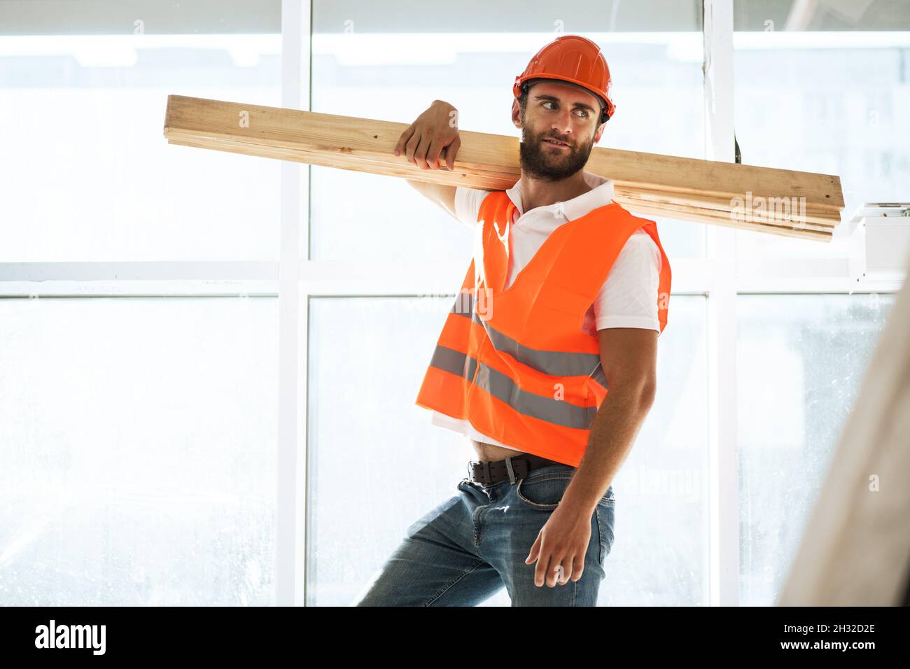 Builder carrying wood on shoulder hi-res stock photography and images ...