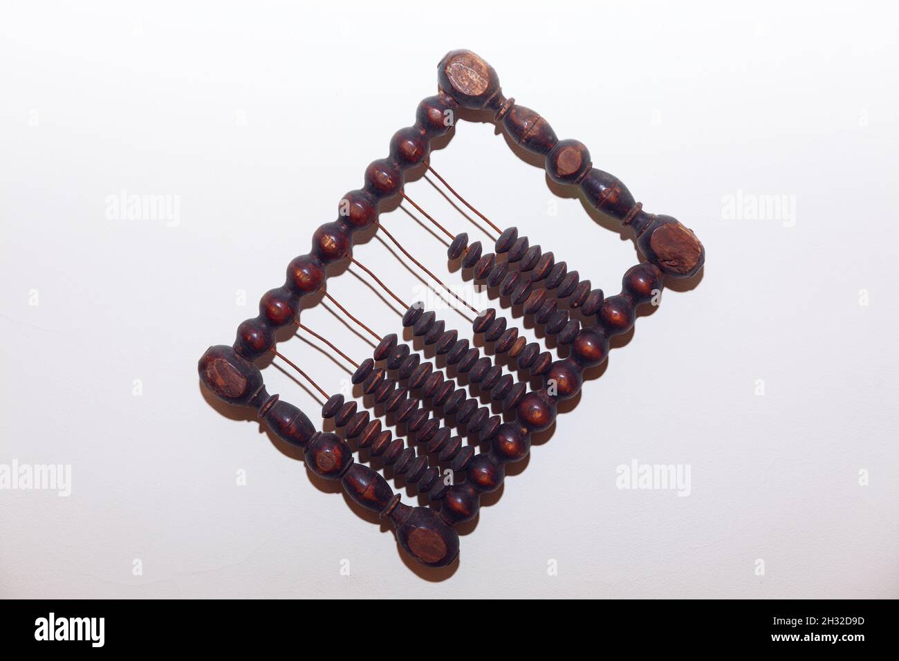 Old abacus on the white wall . Ancient counting frame . Antique ...