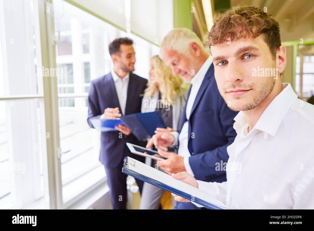 Young man as start-up founder and team in strategy workshop with ...