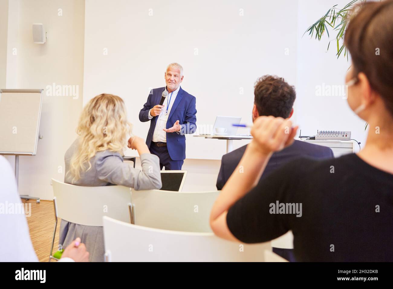 Speaker gives presentation at business conference in front of audience ...