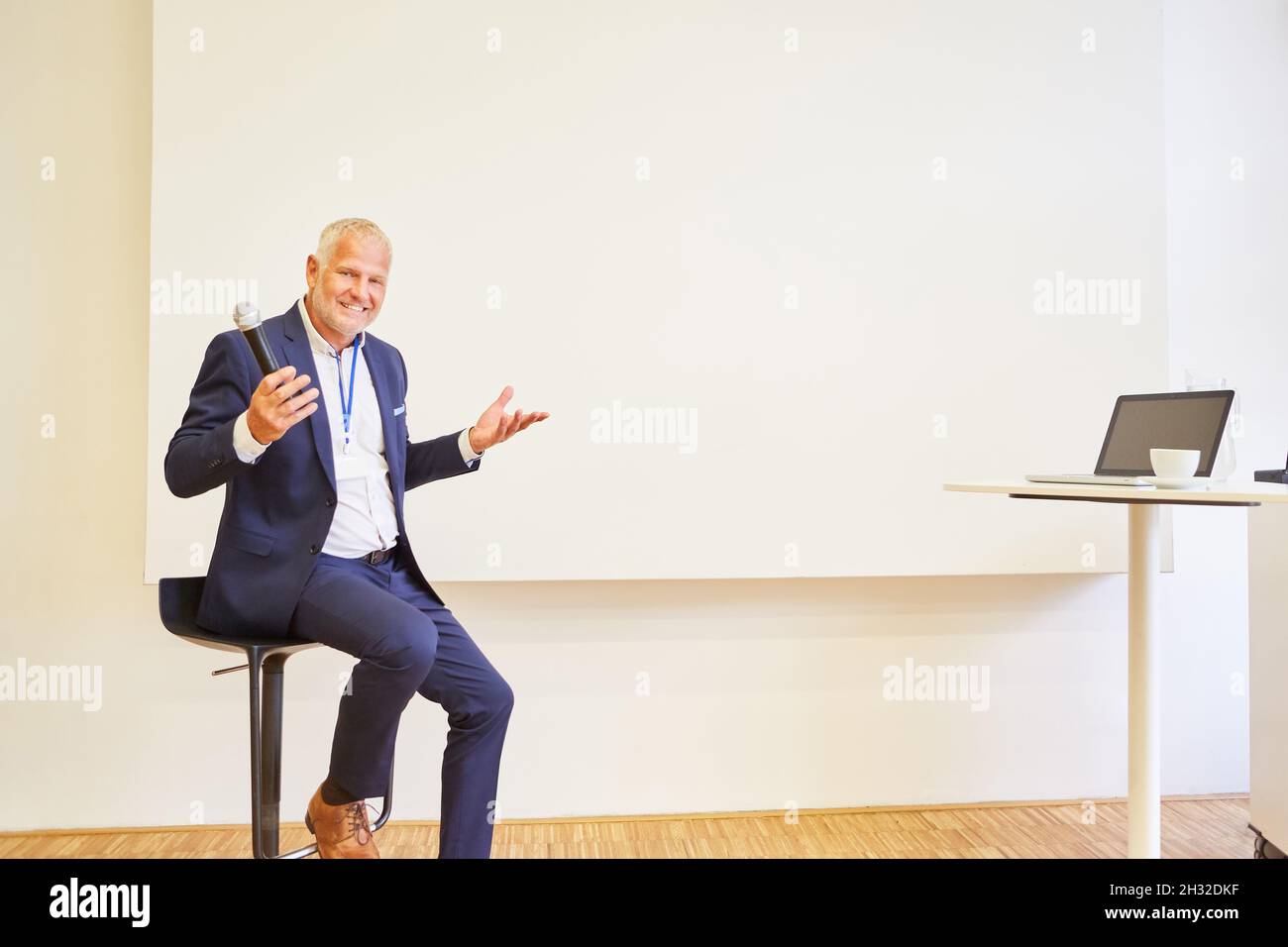 Older businessman as a motivational coach giving a lecture in a seminar ...