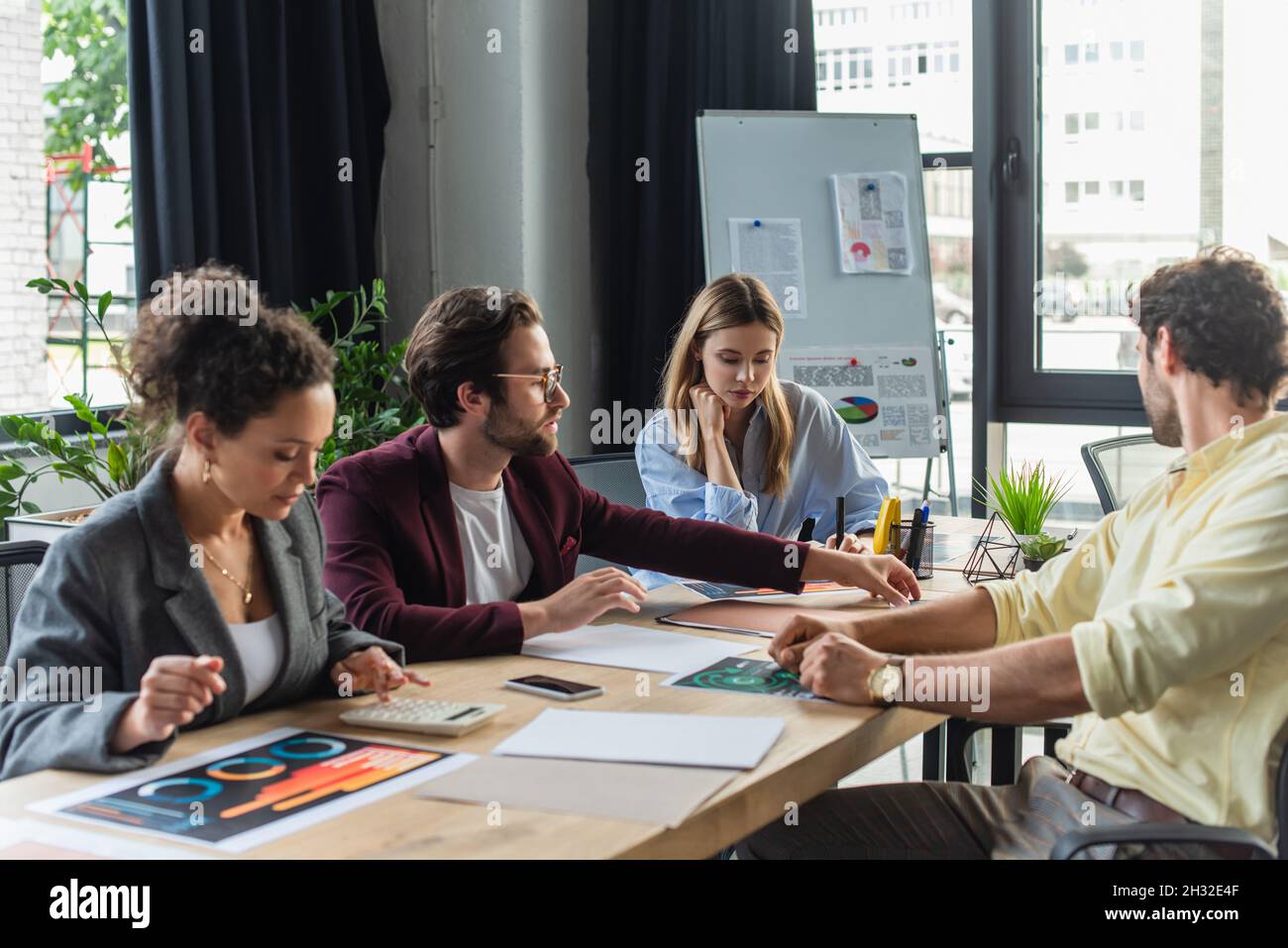 Interracial businesswomen working documents hi-res stock photography ...