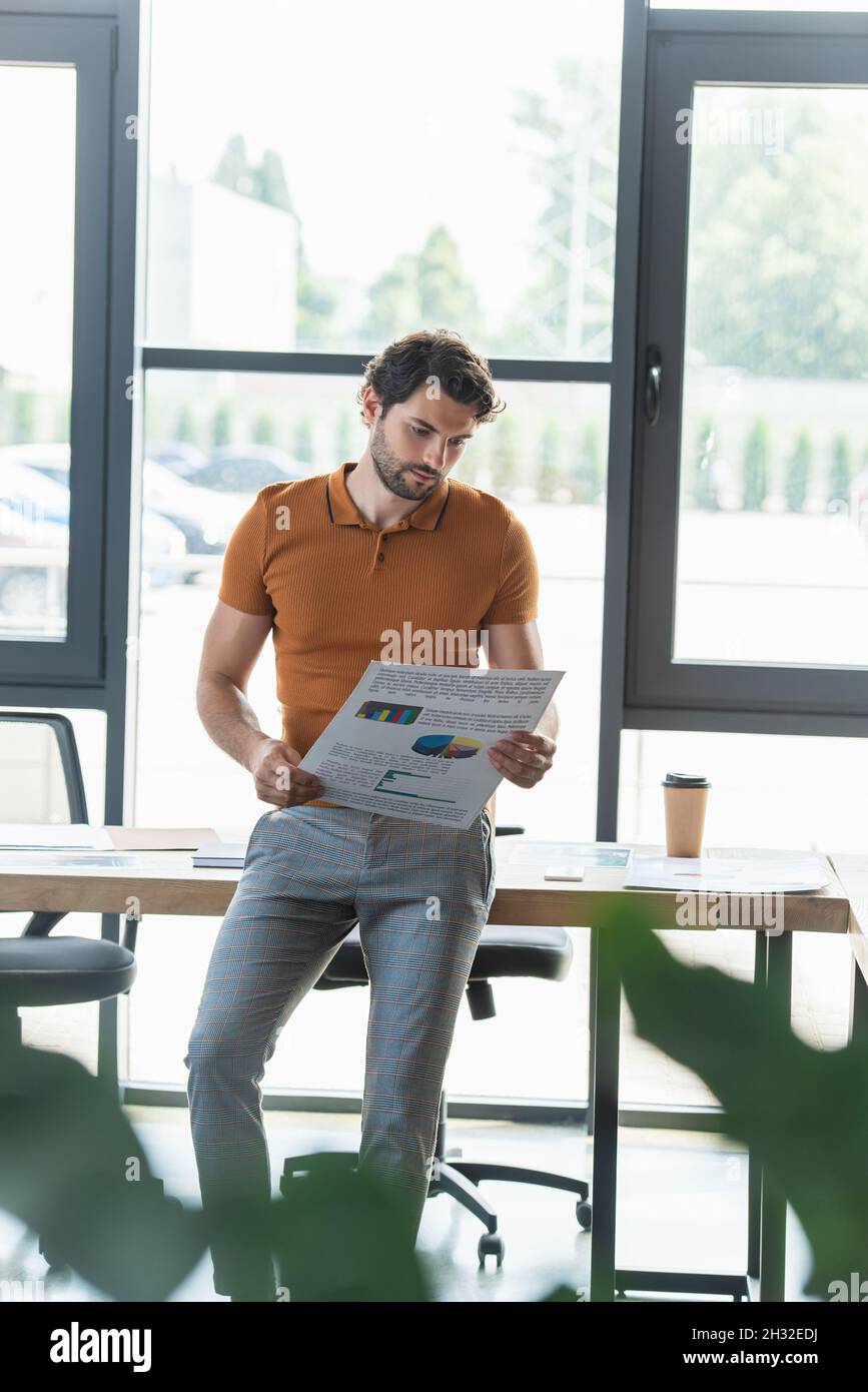 Businessman working with paper near documents on table in office Stock ...