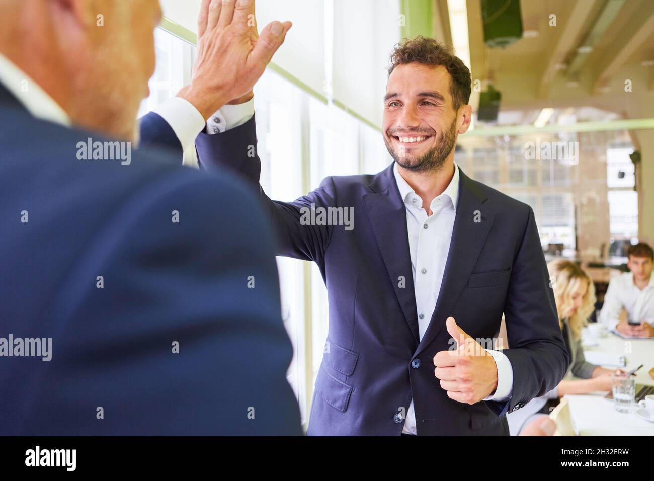 Business man giving high five hi-res stock photography and images - Alamy