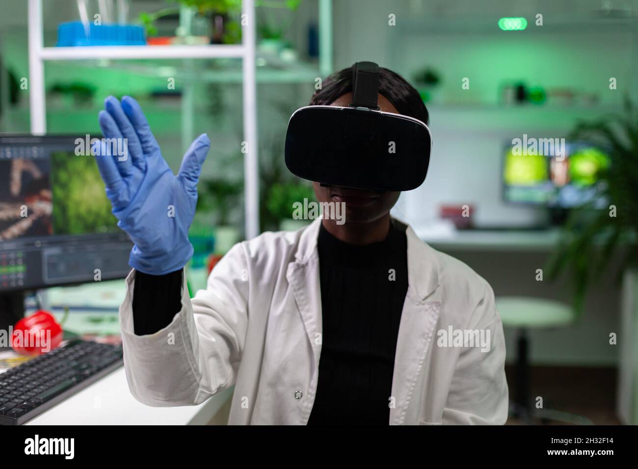 African american biologist woman wearing virtual reality headset during ...