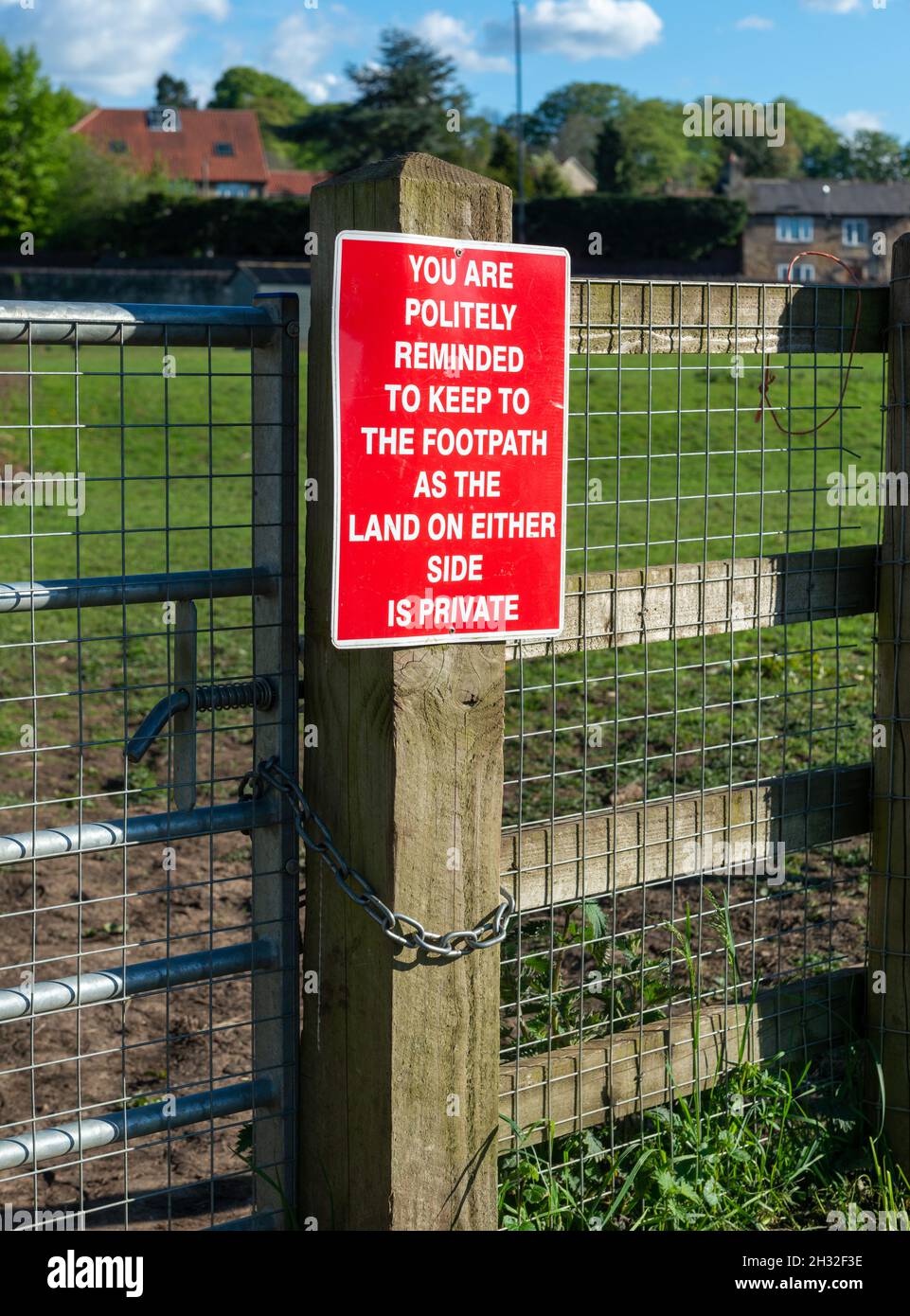 A polite notice on a public footpath asking walkers to keep to the path ...