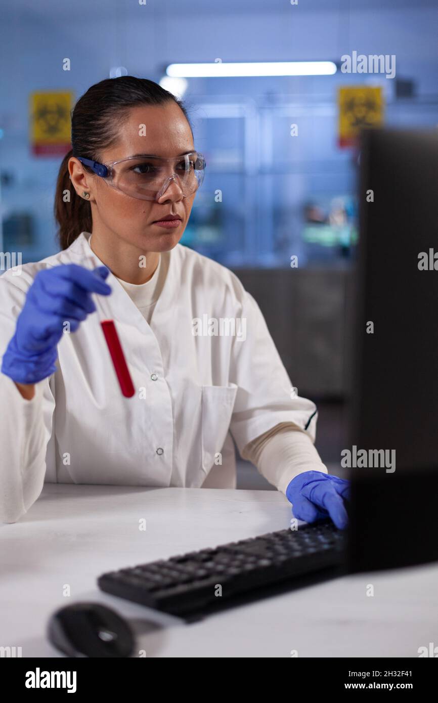 Biochemist doctor woman typing medical expertise on computer after ...