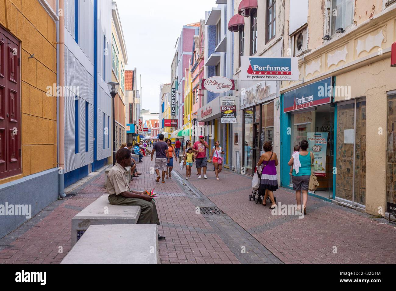 View of people in the colorful alleys of Willemstad in Curacao Stock ...