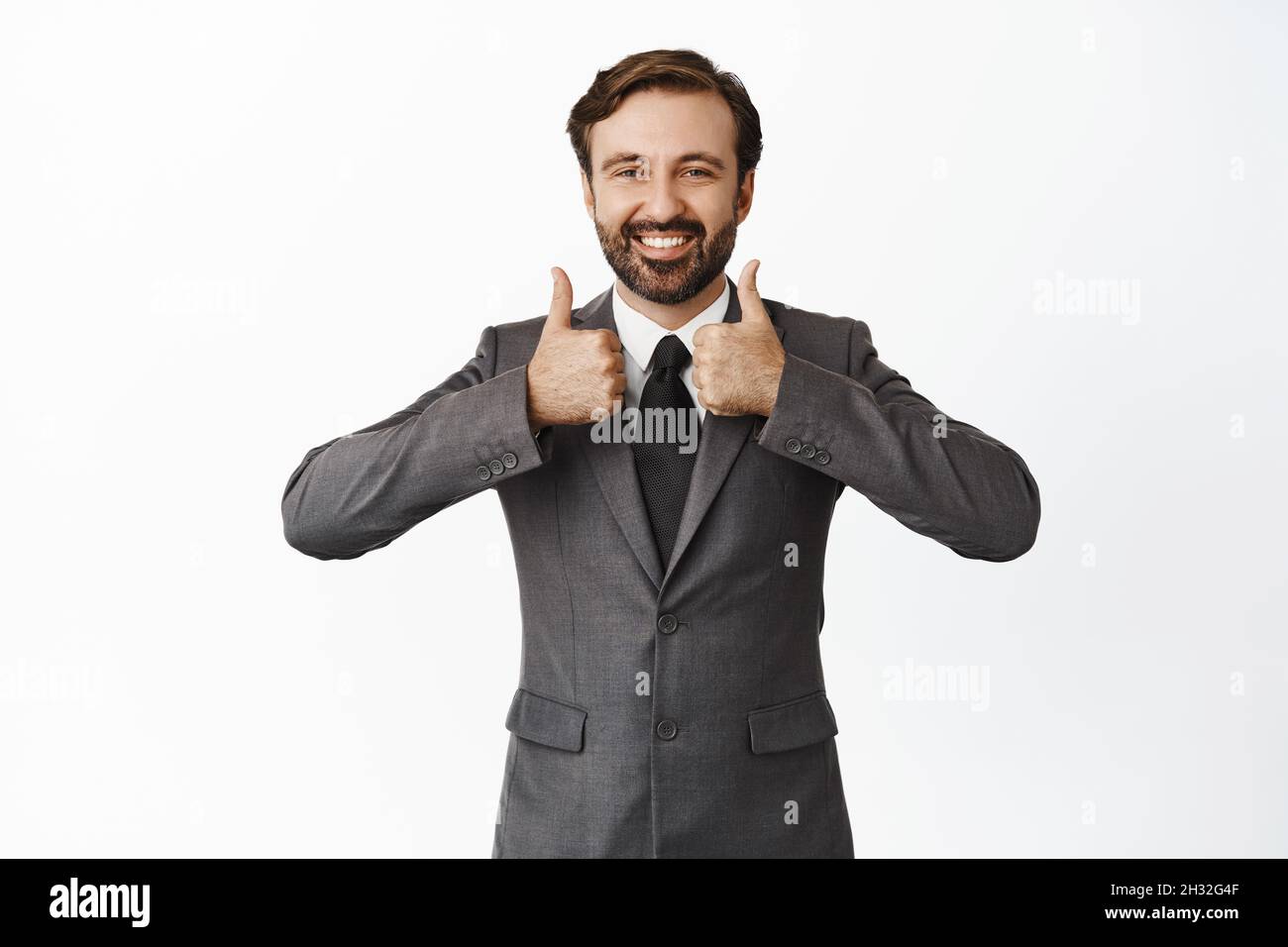 Enthusiastic male boss in suit, showing thumbs up satisfied. Pleased ...