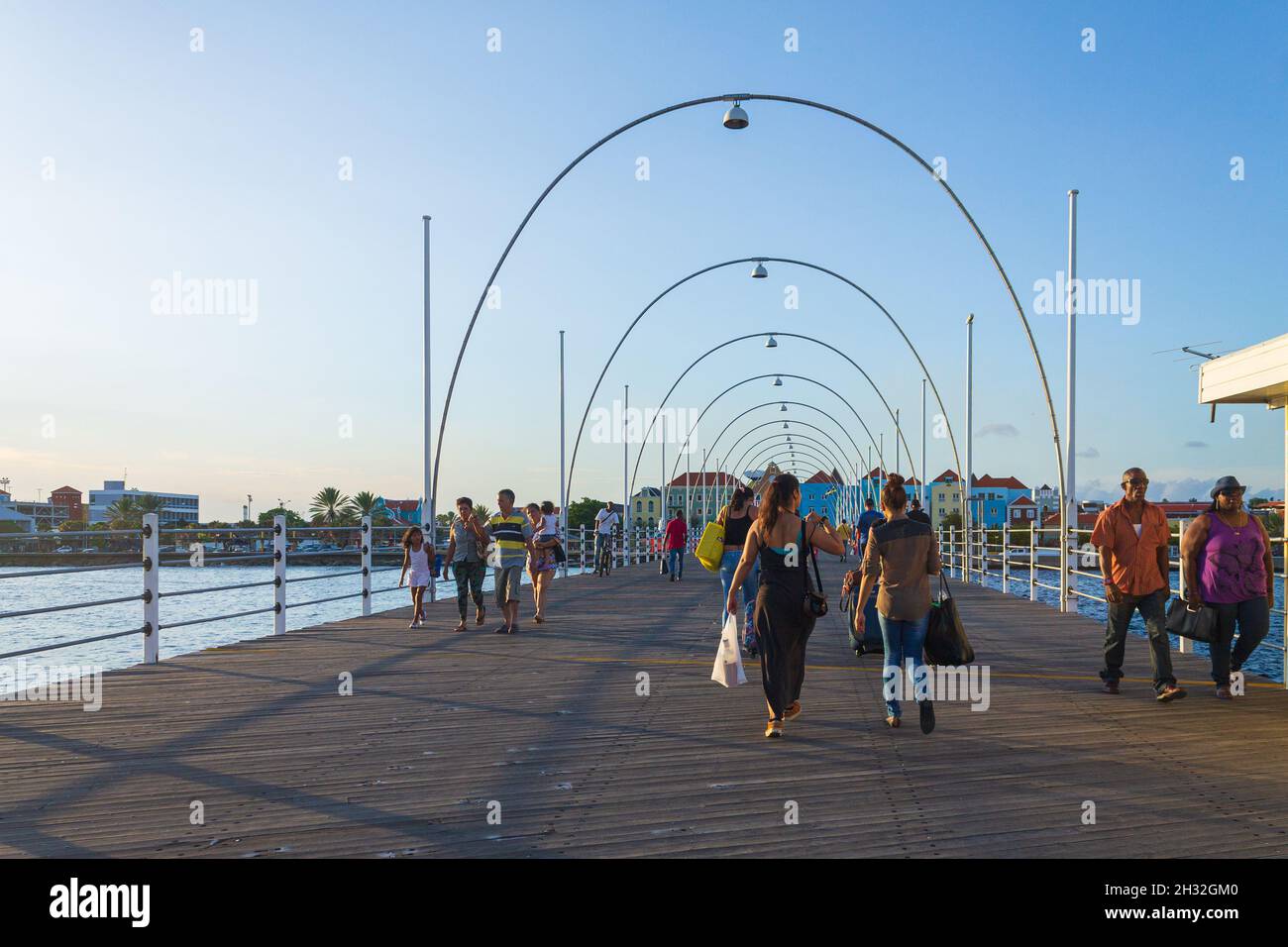 People walking on the Queen Emma floating bridge in Willemstad, Curacao ...