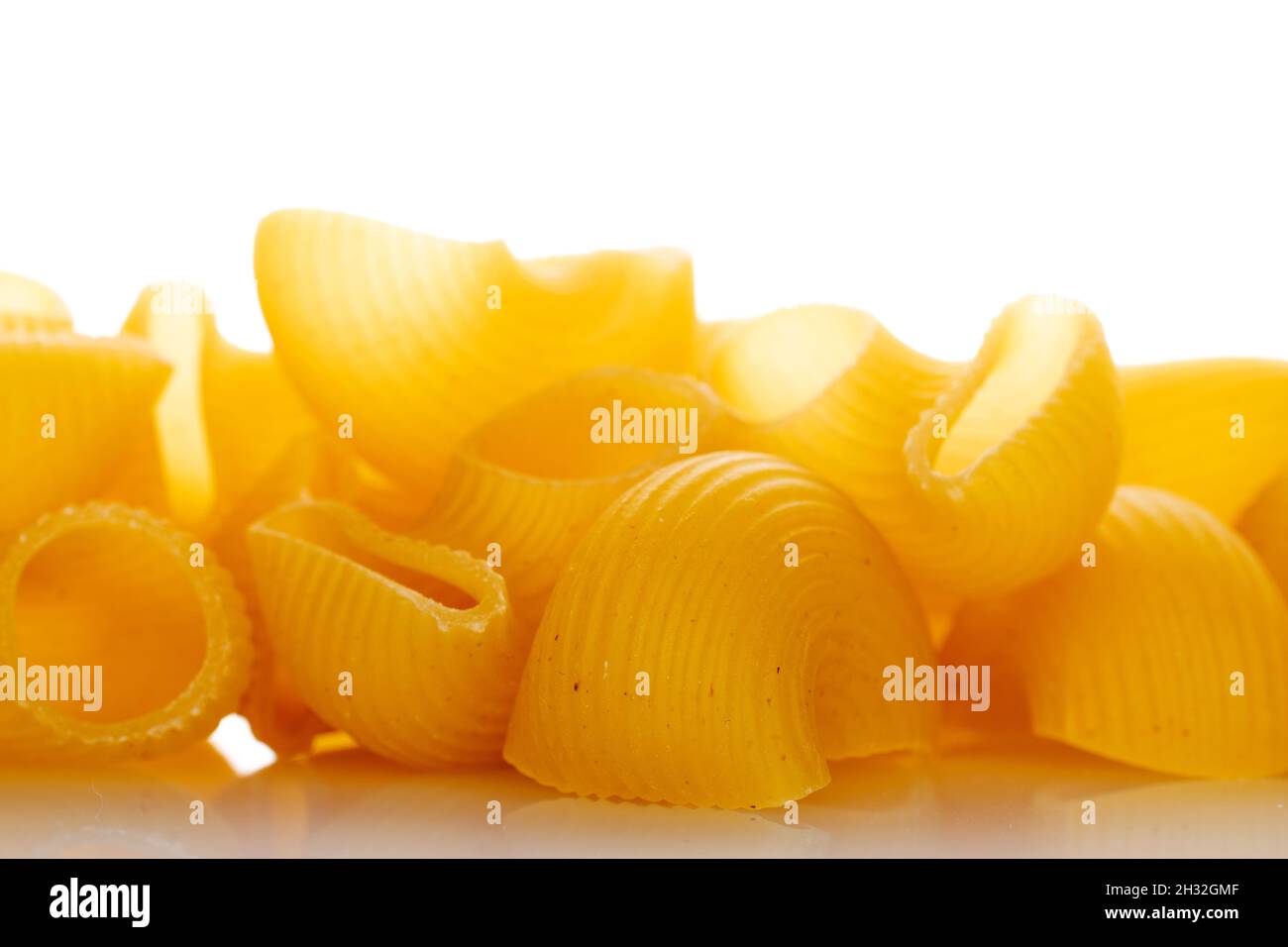 Bright yellow pasta, close-up, isolated on white Stock Photo - Alamy