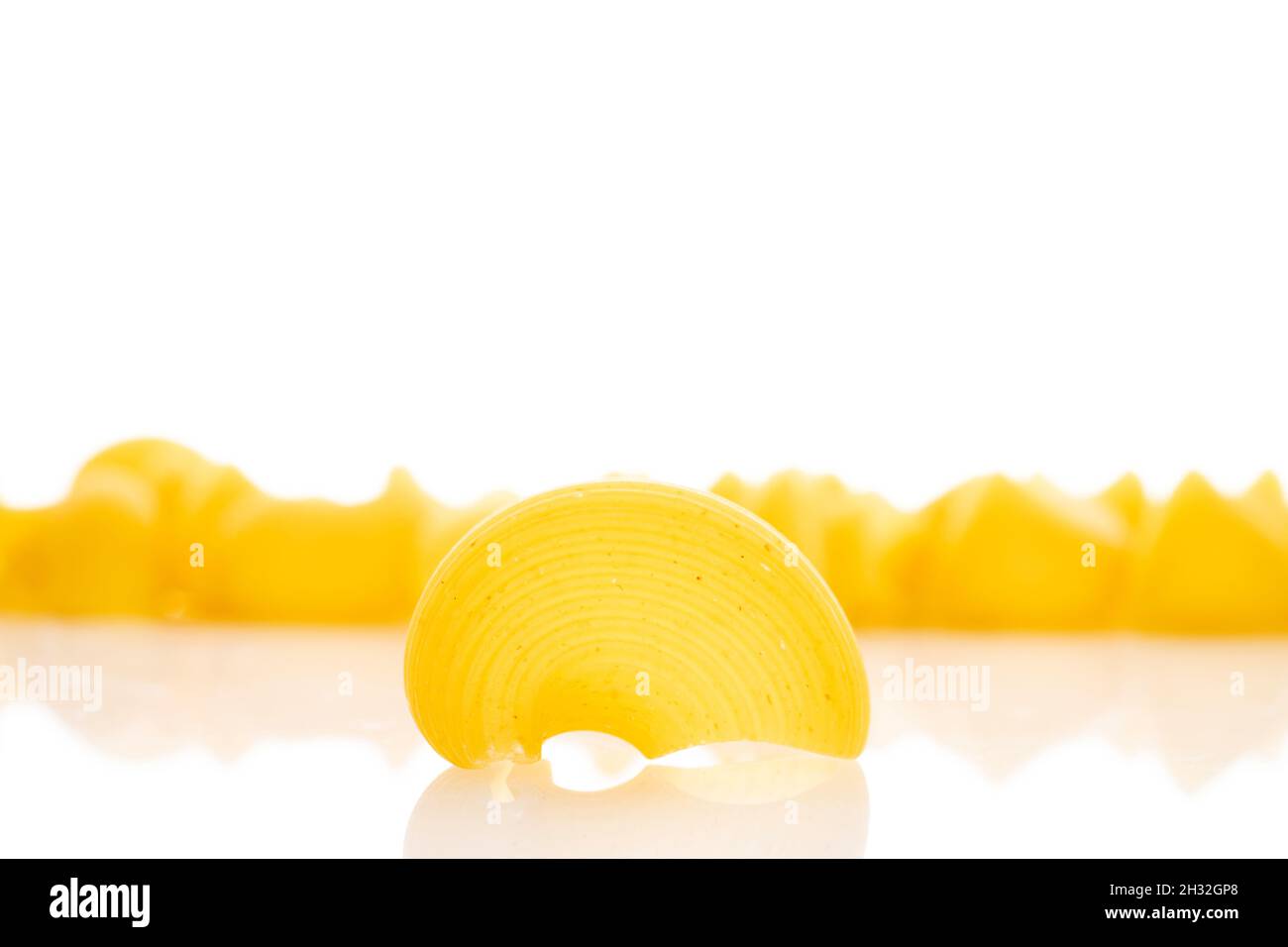Bright yellow pasta, close-up, isolated on white Stock Photo - Alamy