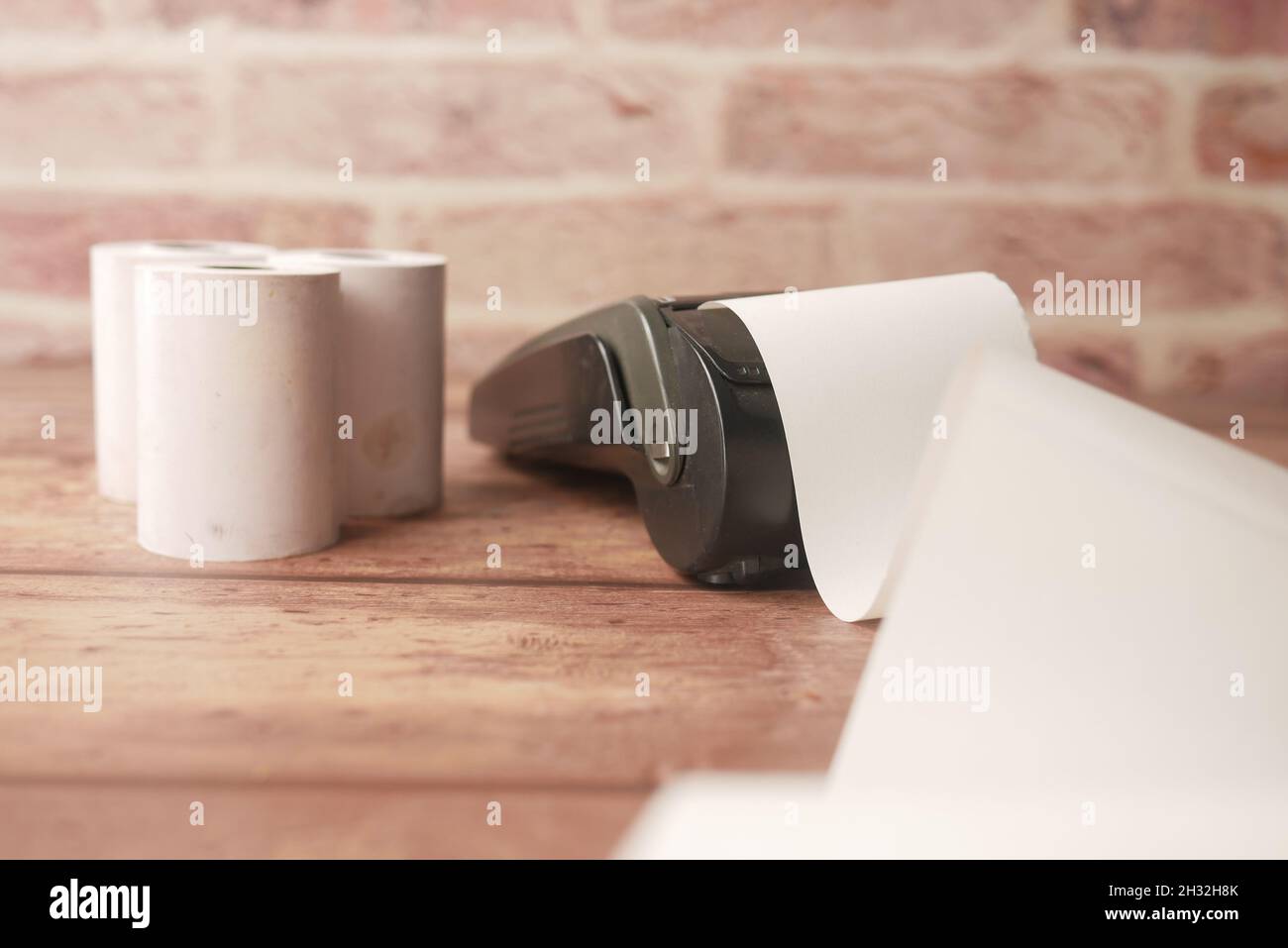 POS machine and long roll paper on table Stock Photo - Alamy