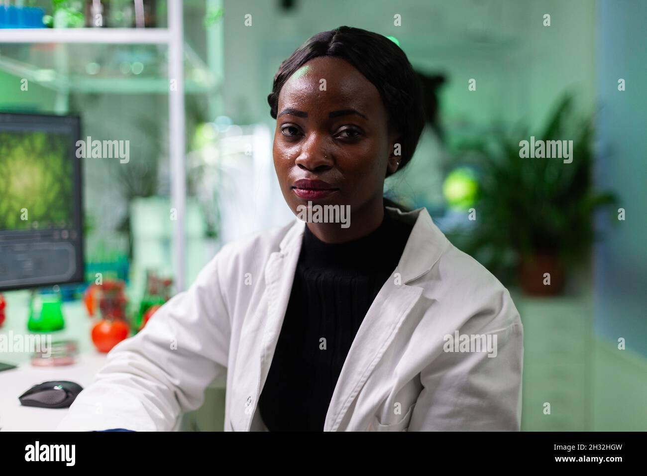 Portrait of african american botanist scientific doctor looking into ...