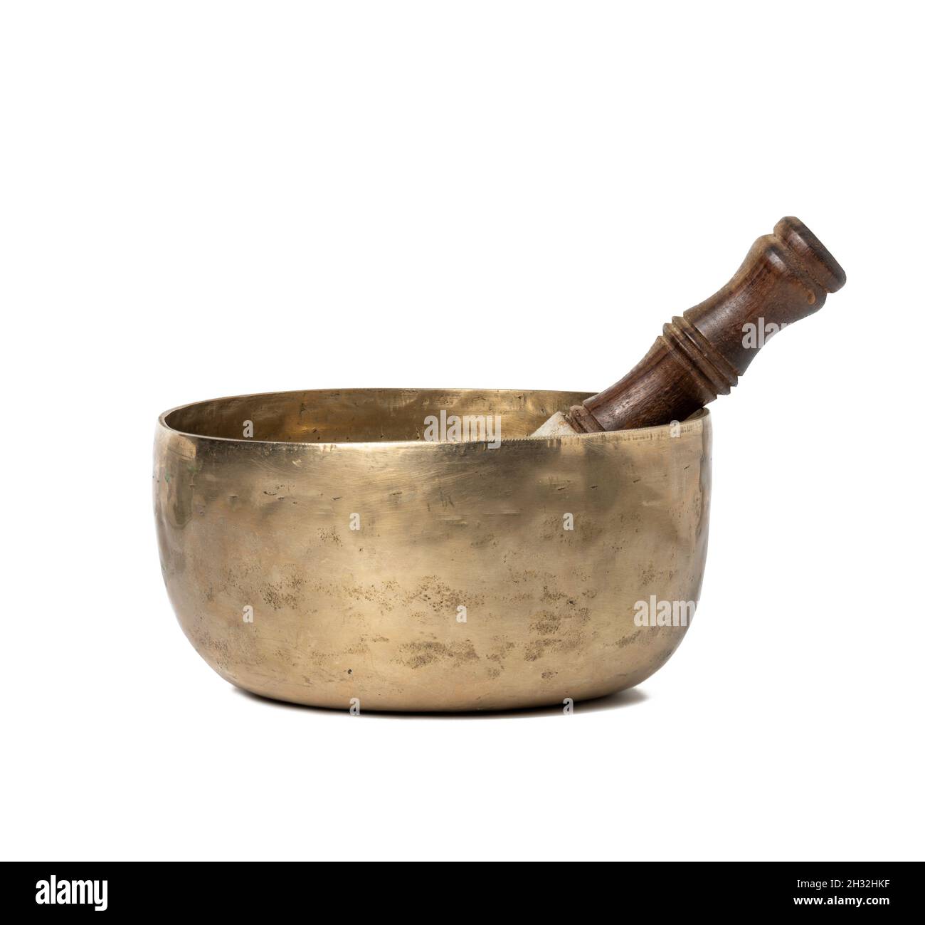 copper singing bowl and wooden mallet isolated on white background ...