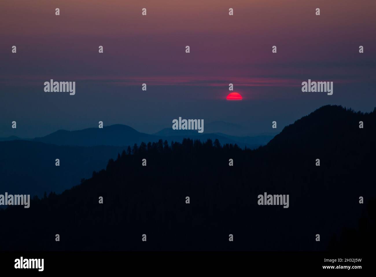 Sunset over mountains and forest, Mountain black silhouette, red sun ...