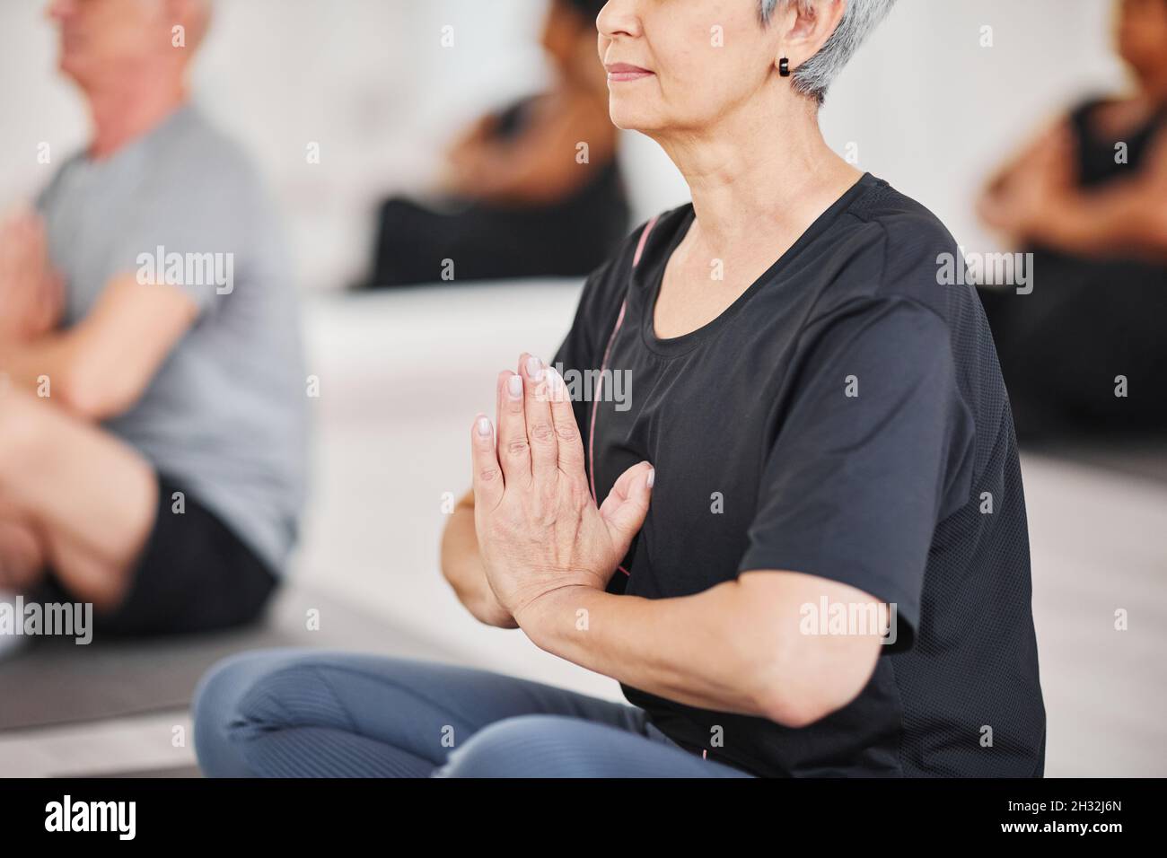 Senior woman sitting in lotus hi-res stock photography and images - Alamy