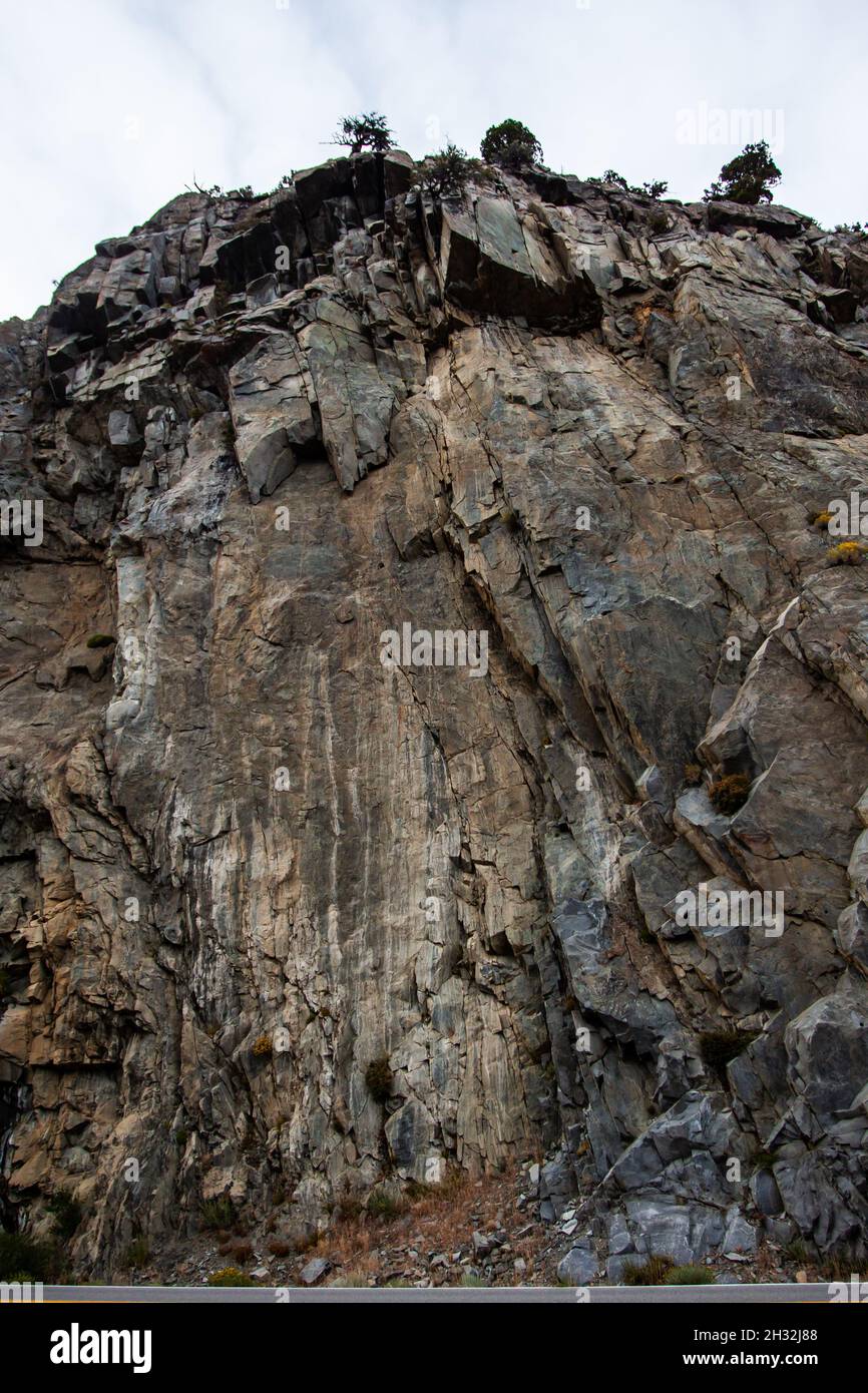 Stunning high rocky cliff walls by the road with trees on top, Amazing ...
