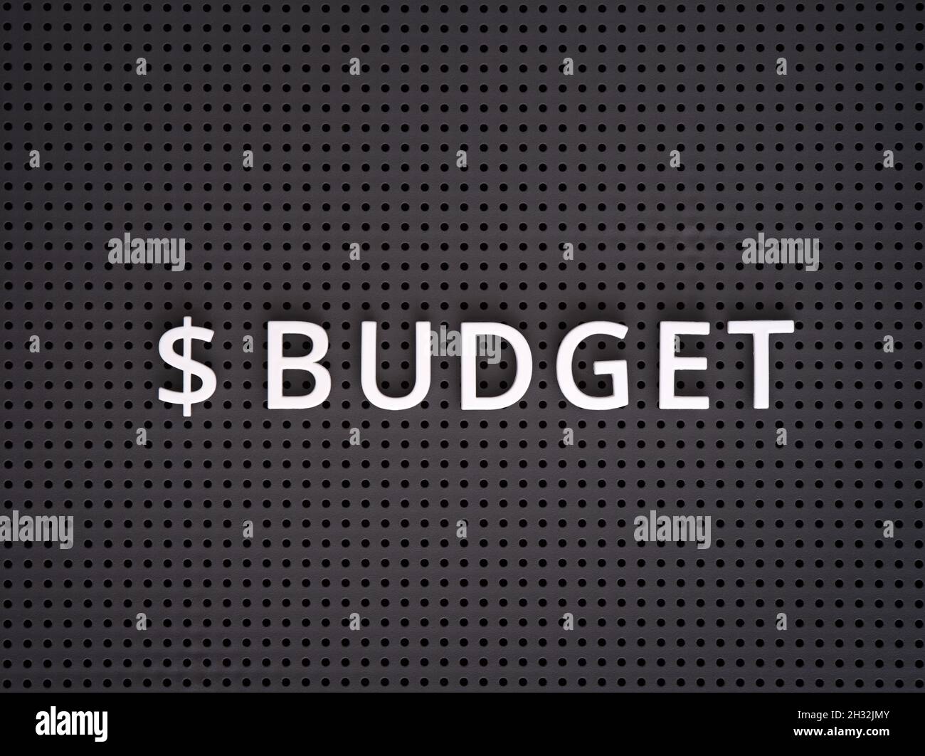 Word Budget with dollar symbol spelled out with white letters on a gray ...