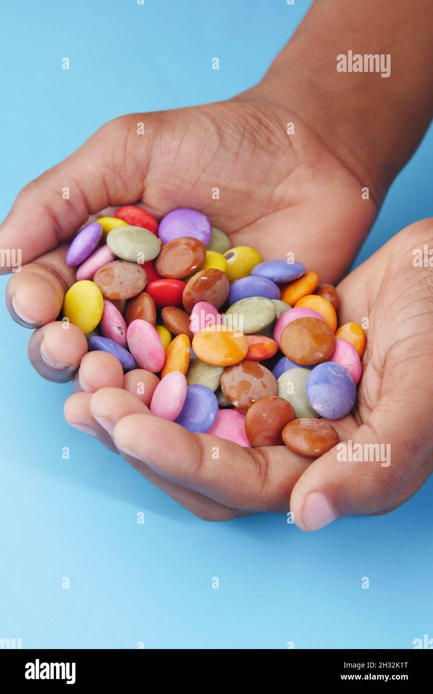 child boy picking multi-colored sweet candies in a bowl close up Stock ...