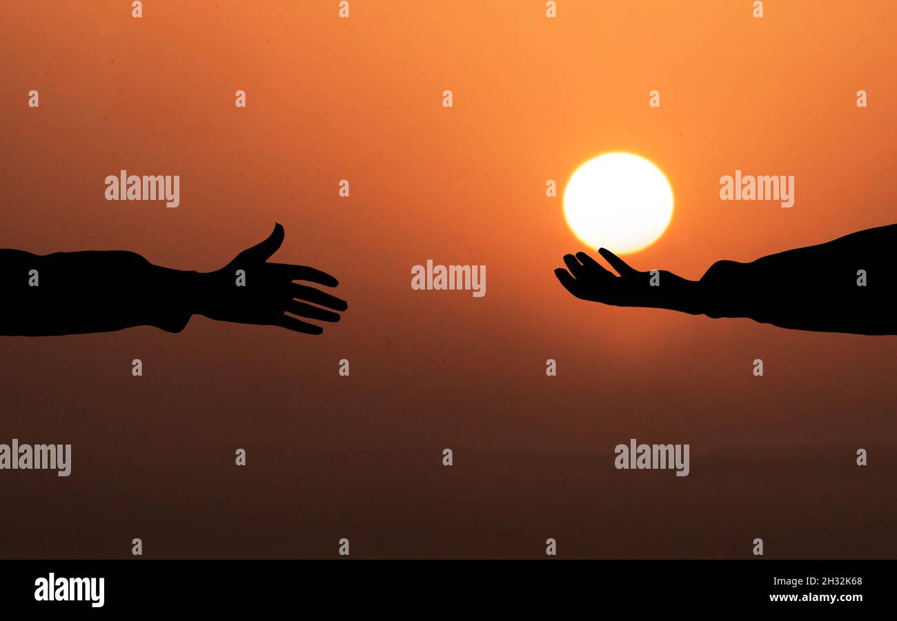 Human hand holding the Sun and giving it To another person. Helping ...