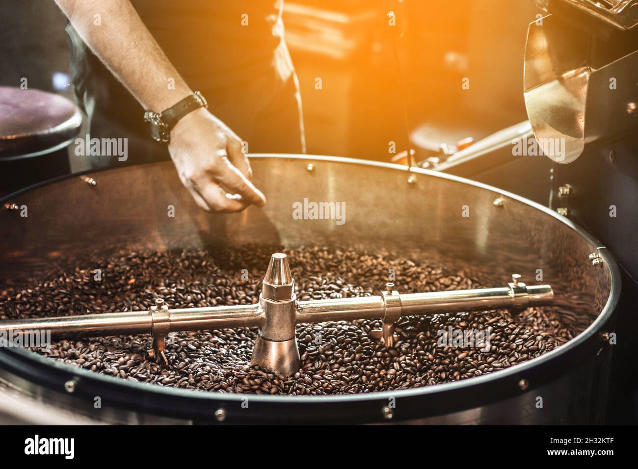 Fresh roasted coffee. Roasting process of coffee beans at factory Stock ...