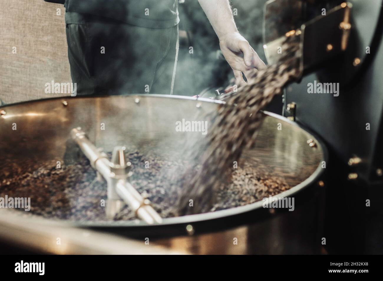 Roasting process of fresh coffee beans at factory Stock Photo - Alamy
