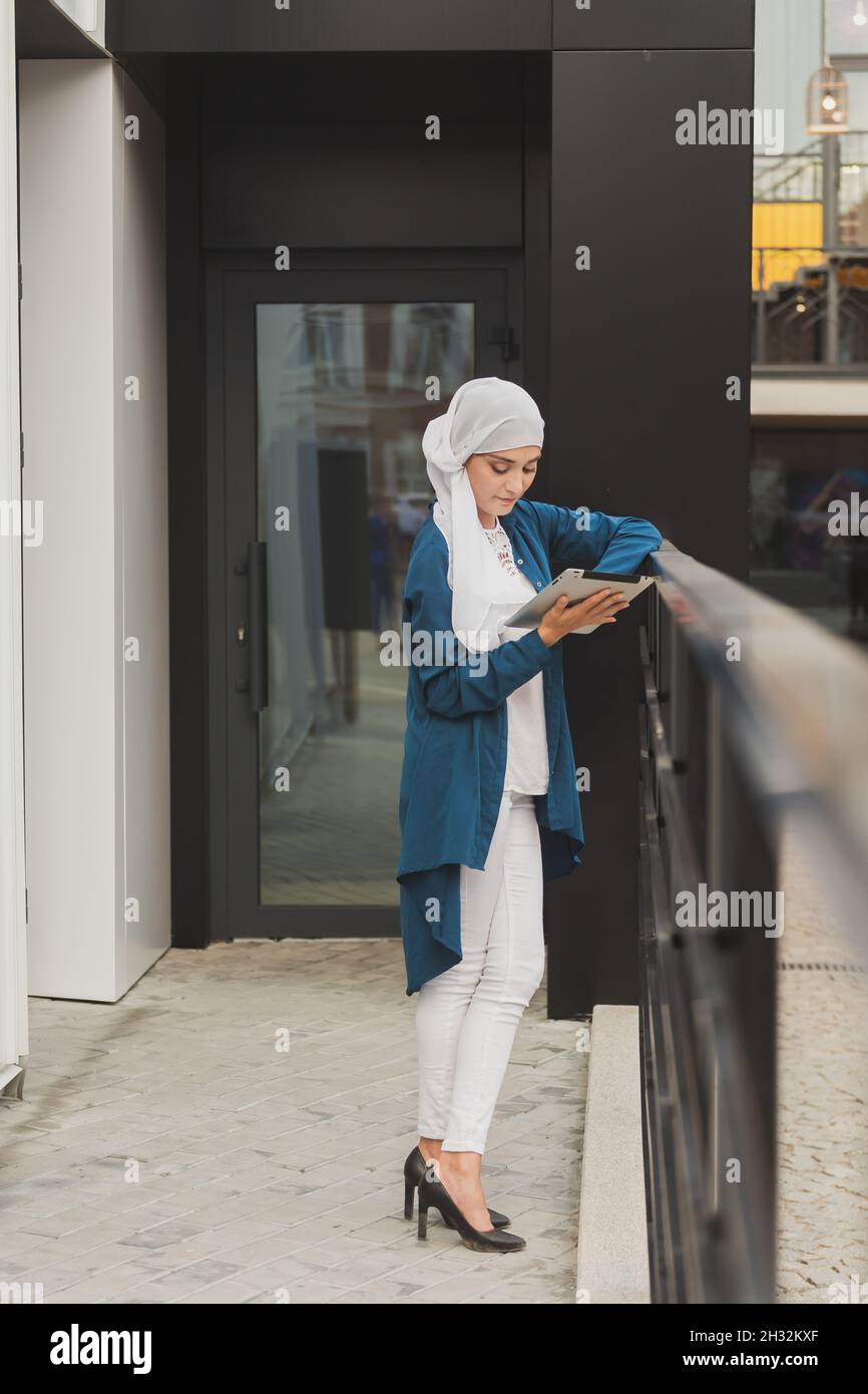 Modern Arabian muslim woman with tablet computer outdoors Stock Photo ...